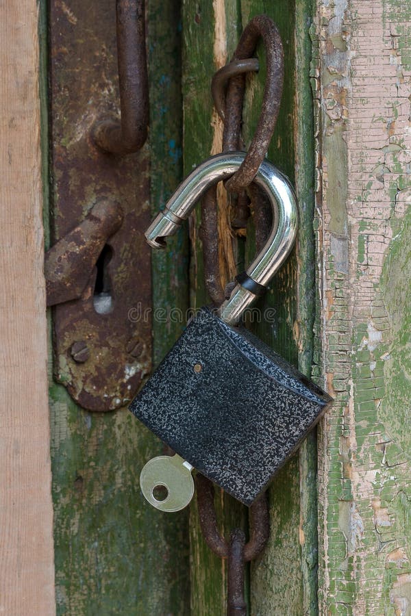 Open Lock with a Key Hanging on an Old Door Stock Photo - Image of ...