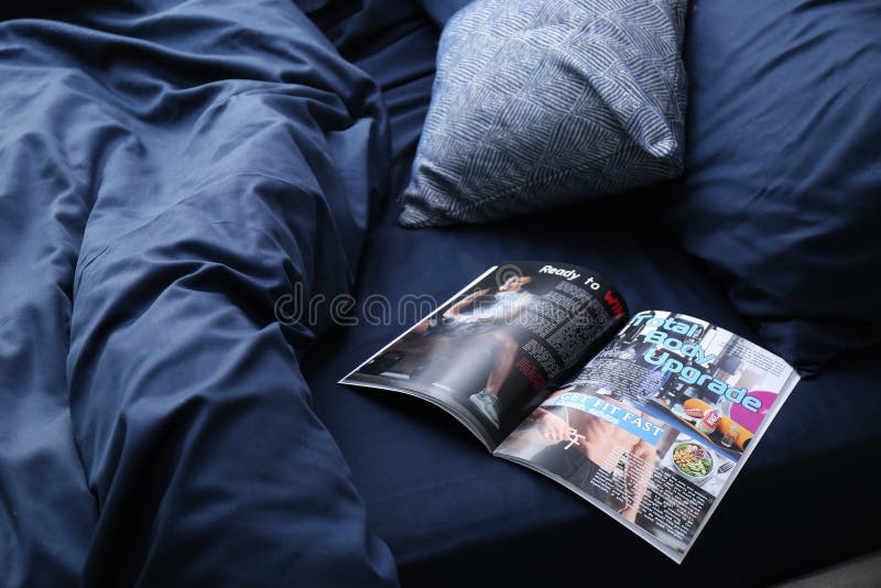 Open Magazine on Bed with Stylish Silky Linens Stock Image - Image of ...