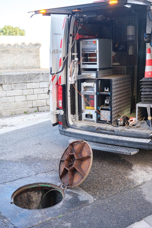 Open Manhole Cover and Workers with Repair Tools Stock Photo - Image of ...