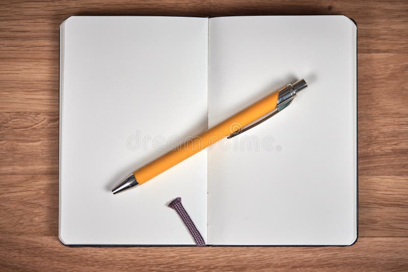 Open Notebook and Ballpoint on a Brown Wooden Table Stock Photo - Image ...