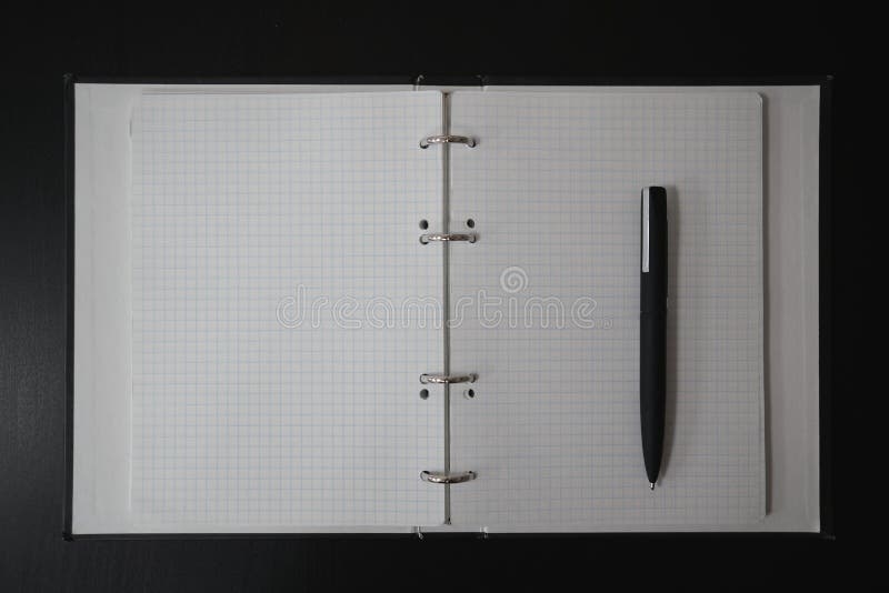 Open Notebook and Black Pen on a Black Wooden Table Stock Image - Image ...
