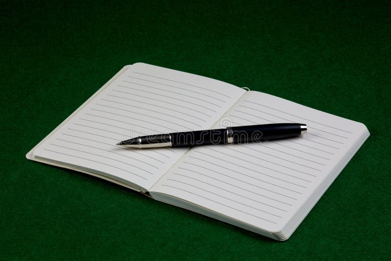 Open Notebook with Black Rollerball Pen on a Felt Table Top Stock Image ...