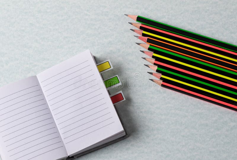 Open Notebook with Colored Bookmarks and Pencils on a Table. Stock ...