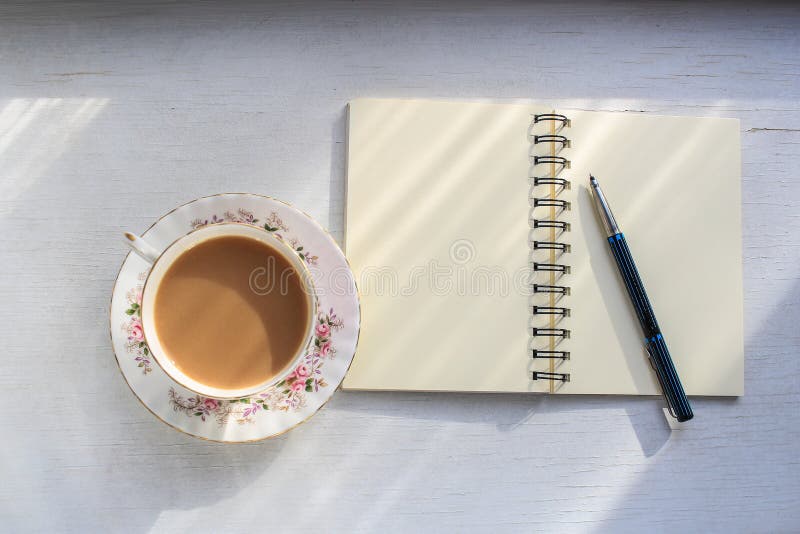Open Notebook and Cup of Tea on a Sunny Table Top. Stock Image - Image ...