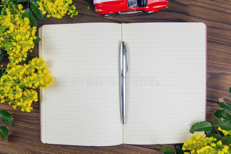 An Open Notebook for Notes, Near Flowering Branches with Yellow Flowers ...