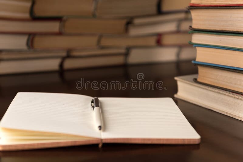 Open Notebook on the Table, on the Background of Books Stock Image ...