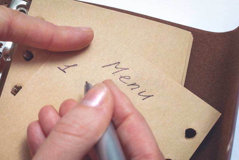 Open Notebook with Words Menu. Young Woman S Hand Writes Menu in ...