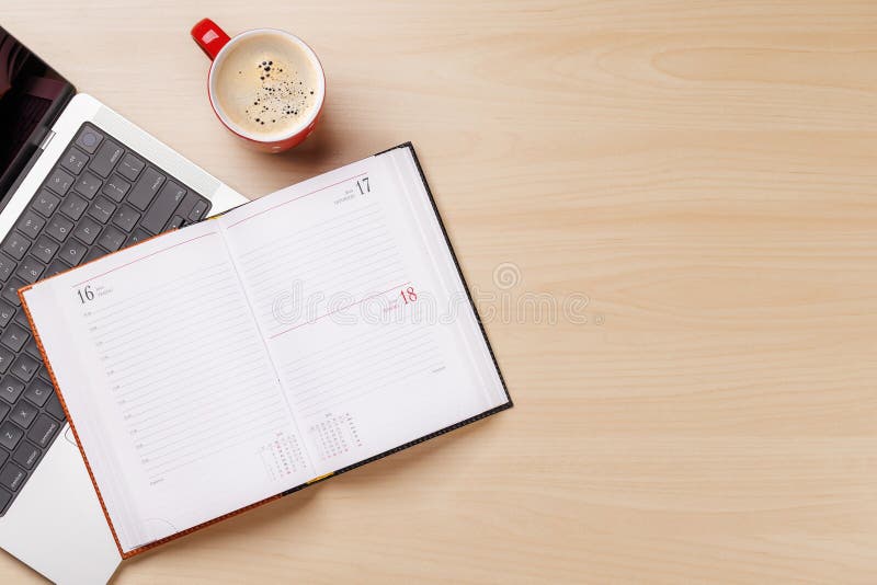 An Open Notepad with Blank Pages Placed on a Desk Alongside a Laptop ...