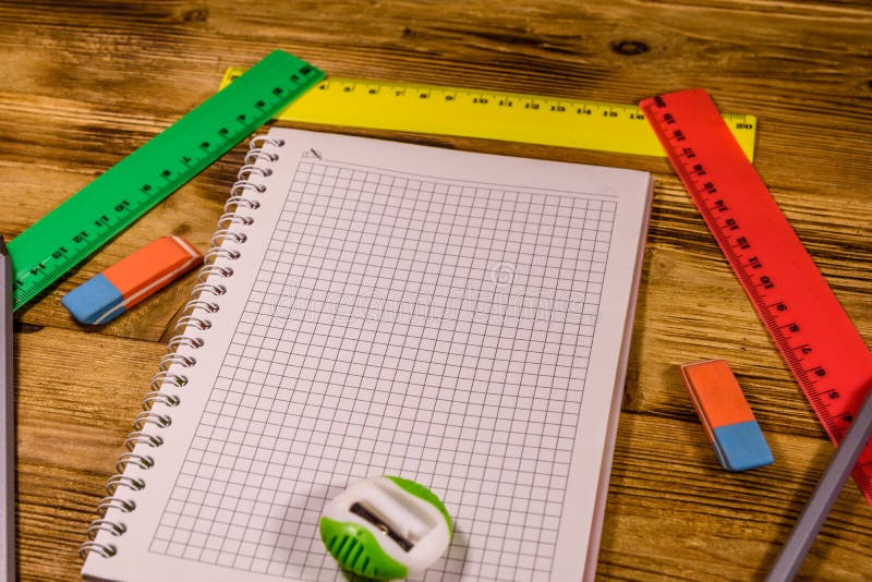 Open Notepad and Different Stationeries on a Wooden Table Stock Photo ...