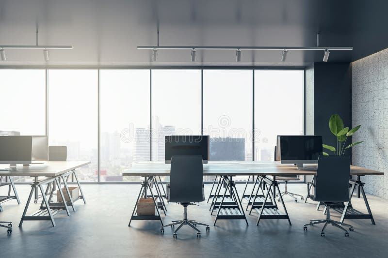 Open Office Interior with Desks, Computers, a Concrete Floor, and Grey ...
