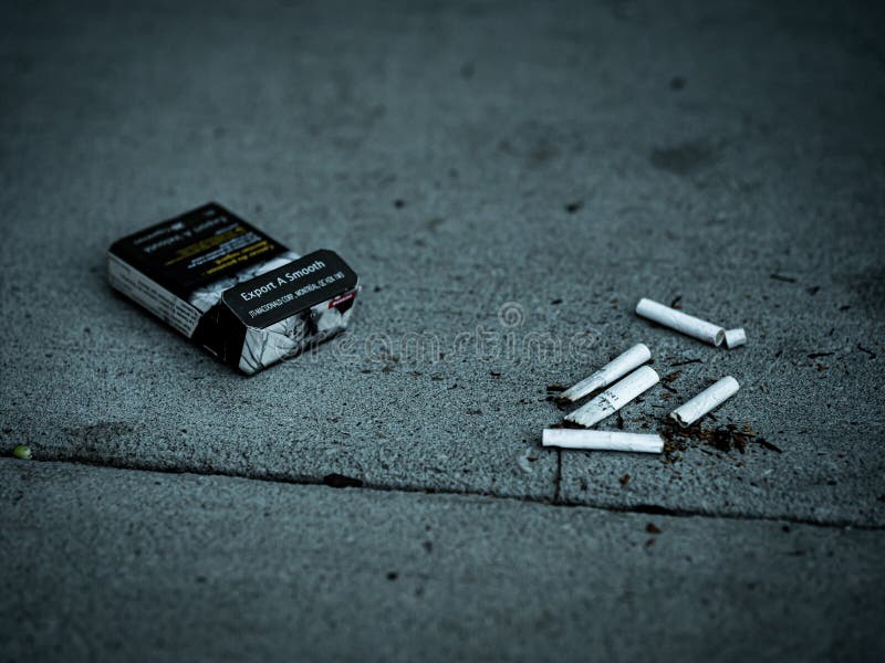 Open Pack of Cigarettes with Several of Them on the Cement Editorial ...