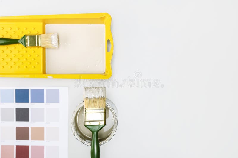 Open Paint Can, Yellow Tray and Brushes on White Surface, Top View ...