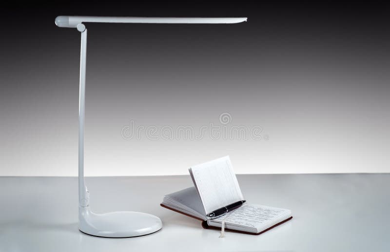Open a Paper Notepad with a Pen on the Table Under the Desktop Lamp ...
