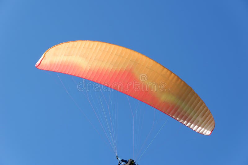 Open Paragliding Parachute of Yellow and Red Colour in the Bright Blue ...