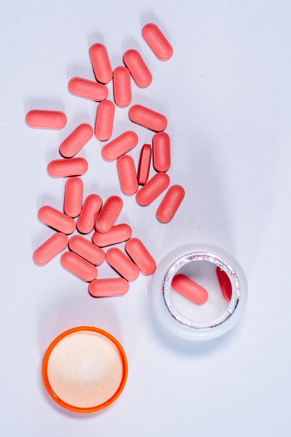 Open Pill Bottle with Scattered Red Tablets on White Background Stock ...