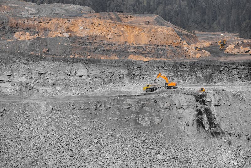 Excavator Work Loading of Coal into Yellow Mining Truck. Open Pit Mine ...