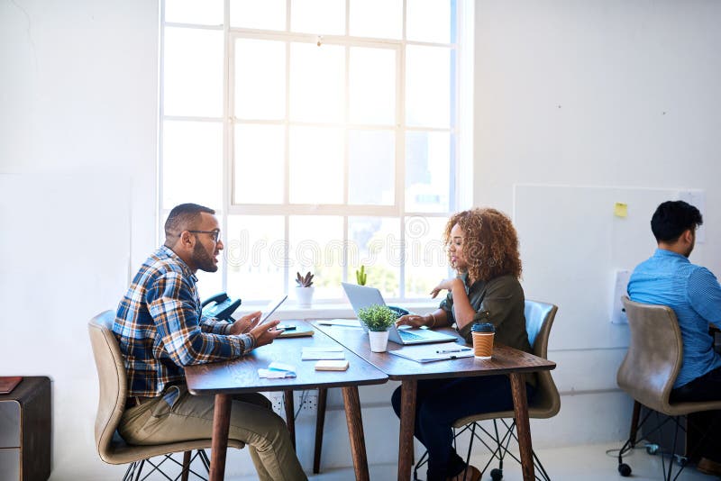 Open Plan Promotes Open Discussions. Two Young Coworkers Having a ...