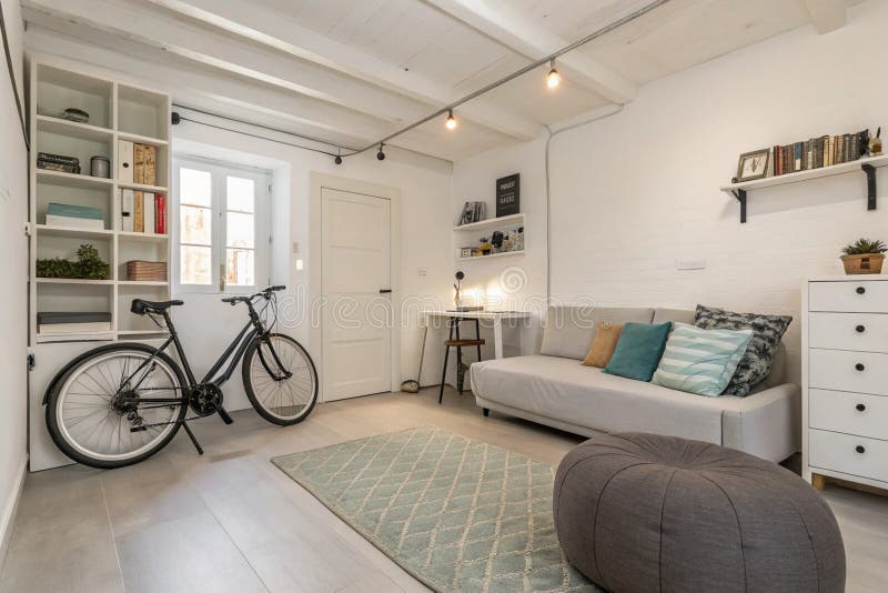 Open-plan White Studio Flat with Sofa, Bike, and Desk Stock Photo - Image of interior, modern ...