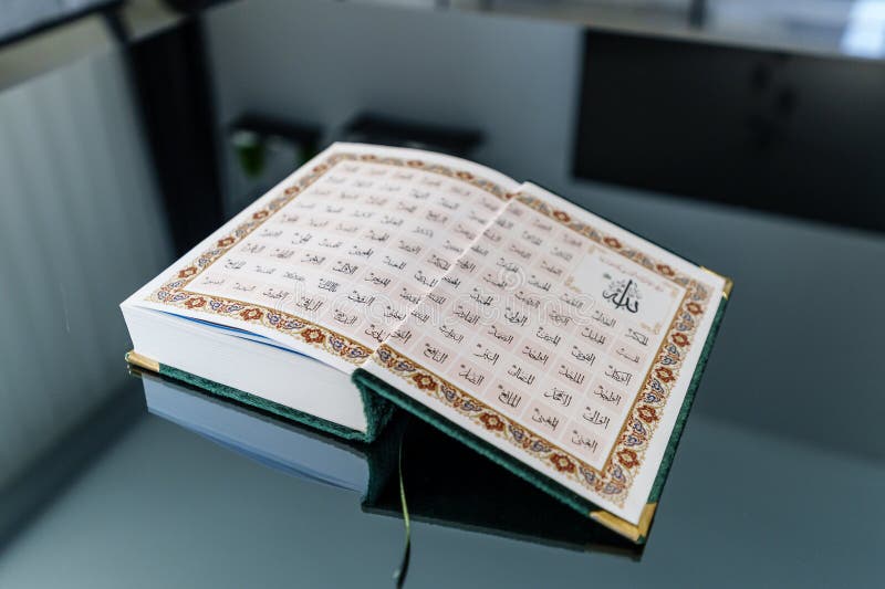 Open Quran Featuring Arabic Script with Blue Decorative Details Stock ...