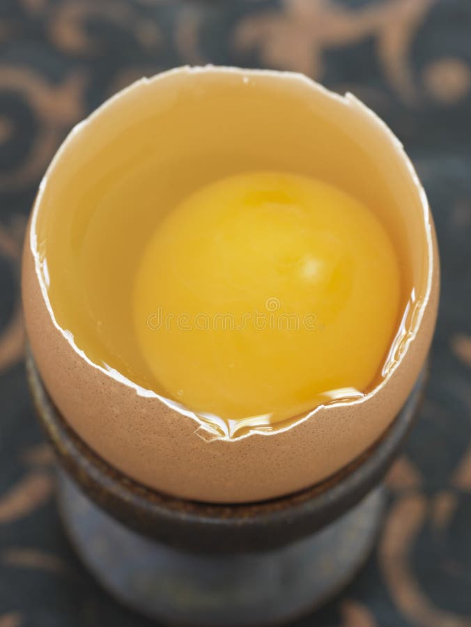 Open raw egg in an eggcup stock photo. Image of classical - 23707932