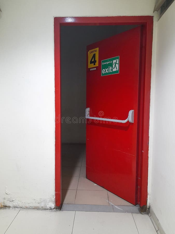 Open Red Door Leading To Empty Corridor with Emergency Exit Signs Stock ...