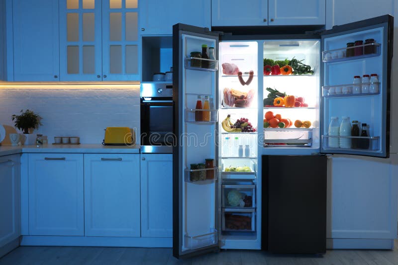 Refrigerator Filled with Food in Kitchen at Night Stock Photo - Image ...