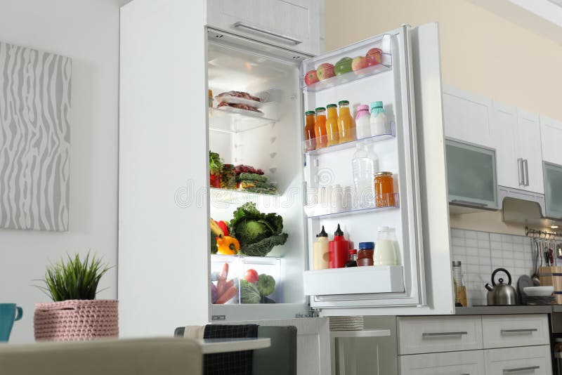 Open Refrigerator Full of Products in Kitchen Interior Stock Image ...