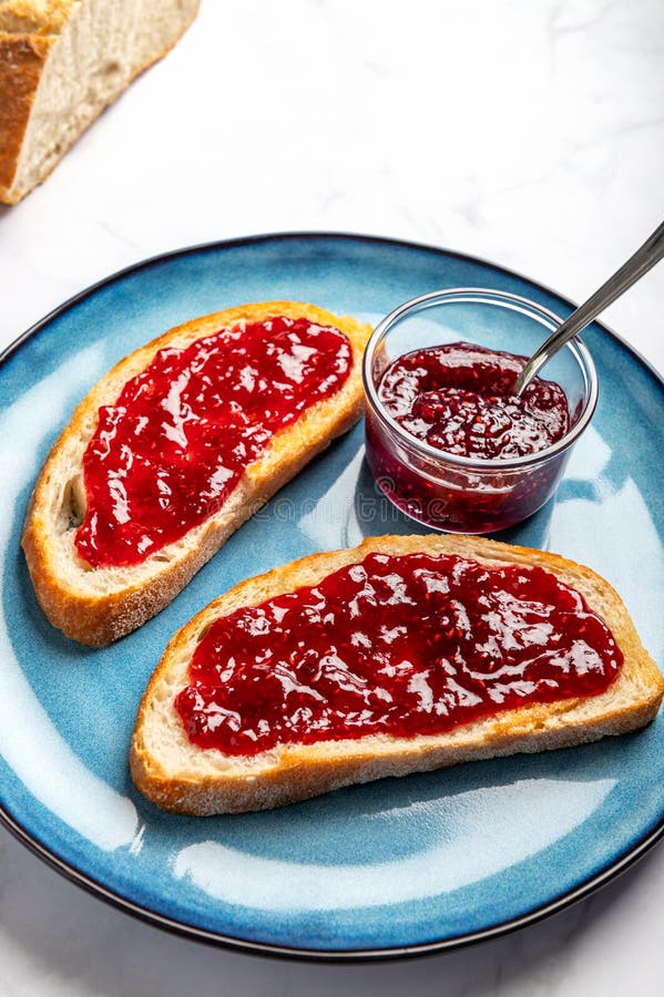 Raspberry jam on toast stock photo. Image of pastry - 268567760