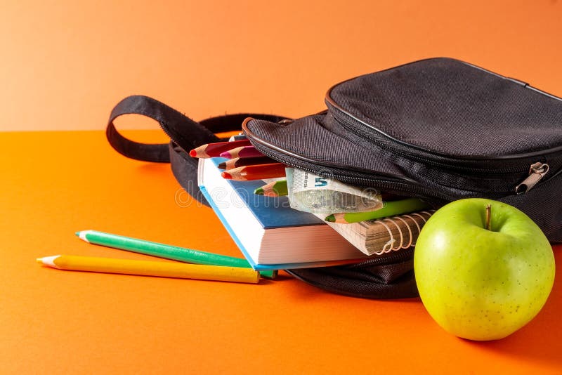 Open School Backpack on an Orange Background. Books, a Notebook and ...