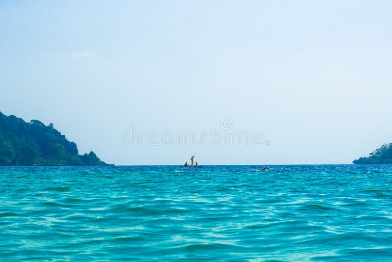 In the Open Sea in the Distance, Tourists Float on a Board. Summer ...
