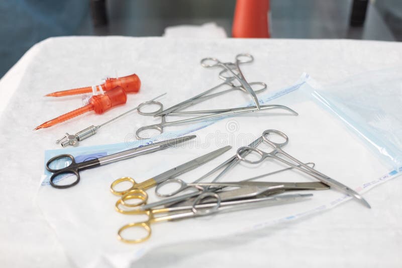An Open Set of Sterile Surgical Instruments Lies on the Table in the ...