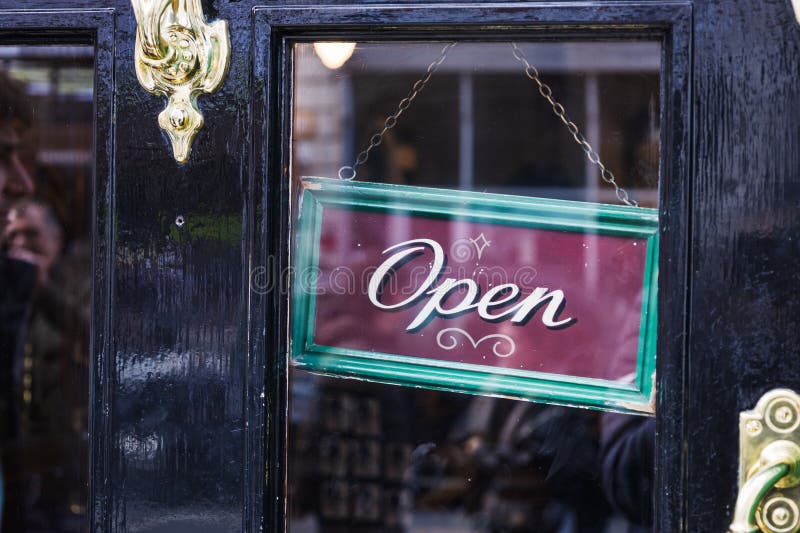 Open Sign Displayed in Window of Black Storefront Inviting Customers ...