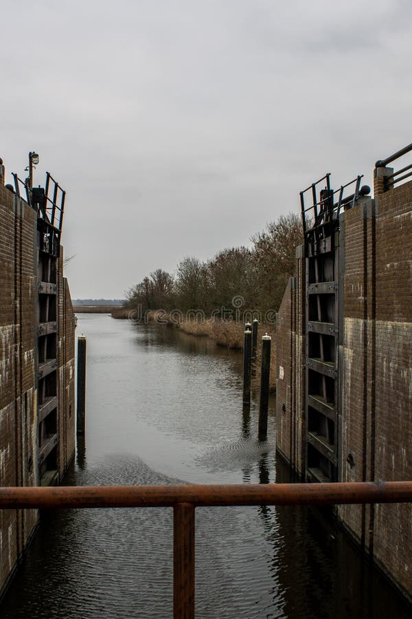 Open sluice in holland stock image. Image of boats, landscape - 135515437