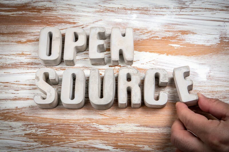 Open Source. Concrete Alphabet Letters on a Light Painted Wood Texture ...