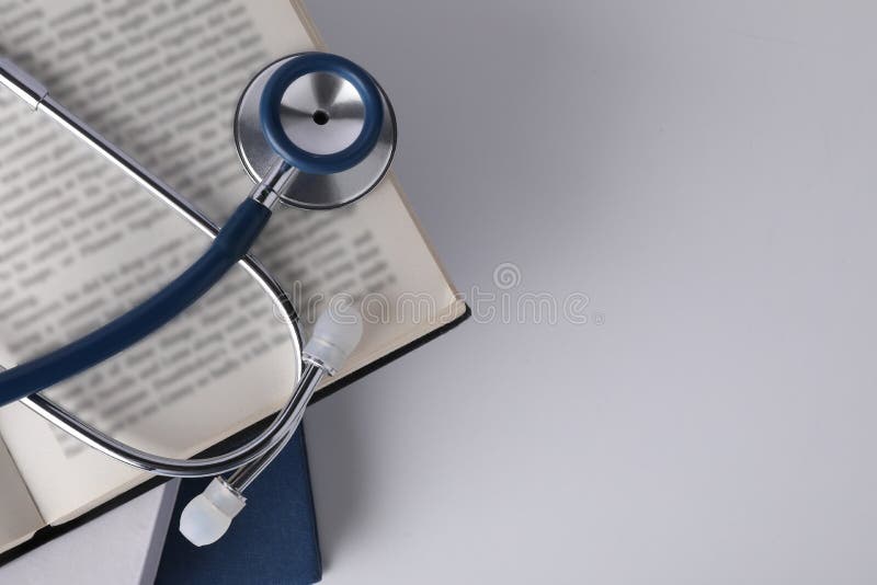 Open Student Textbook and Stethoscope on White Background, Top View ...