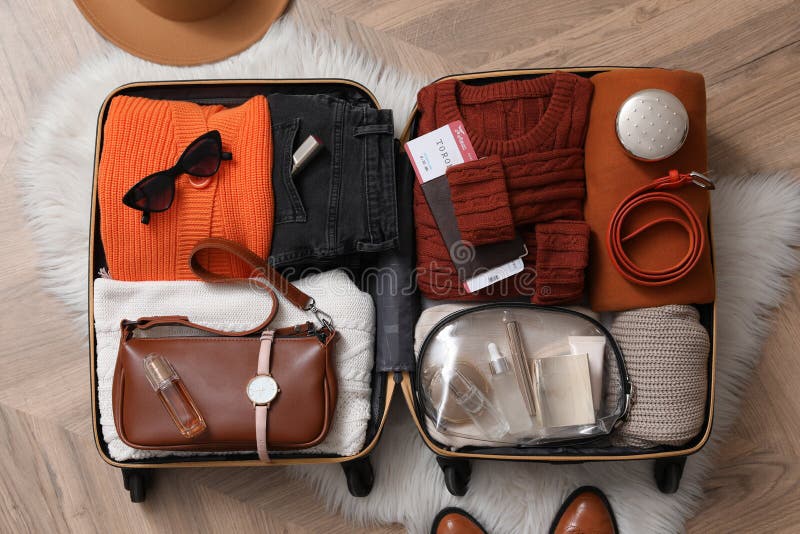 Open Suitcase with Folded Clothes and Accessories on Floor, Flat Lay ...