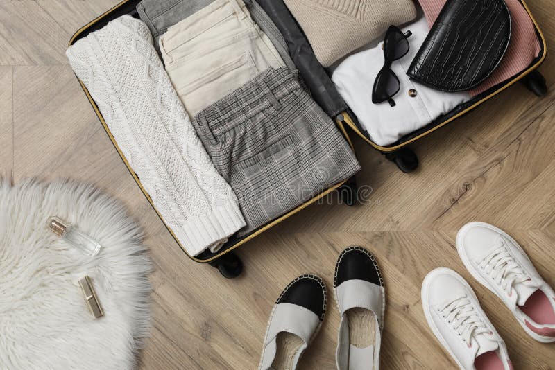 Open Suitcase with Folded Clothes, Accessories and Shoes on Floor, Flat ...