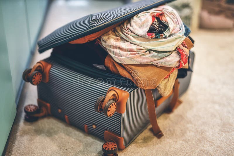 Open Suitcase Full of Clothes in Room. Stock Photo - Image of full ...