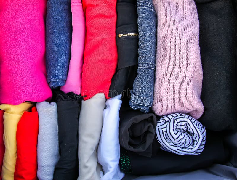 Open Suitcase on the Green Grass with Different Clothes Folded ...