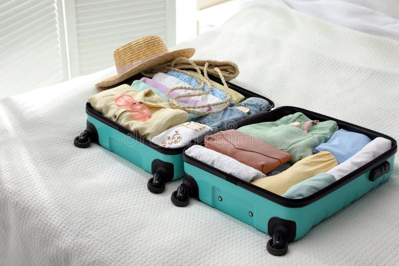 Open Suitcase Packed for Trip and Accessories on Bed Stock Photo ...