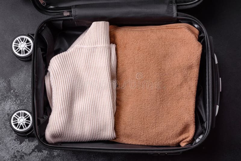 An Open Suitcase with Wheels with Clothes Inside Stock Image - Image of ...
