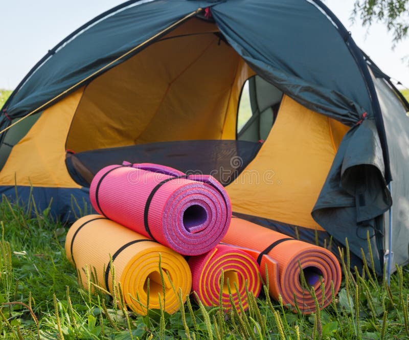 Open Tent and Rolled Sleeping Pads Stock Photo - Image of empty, grass ...