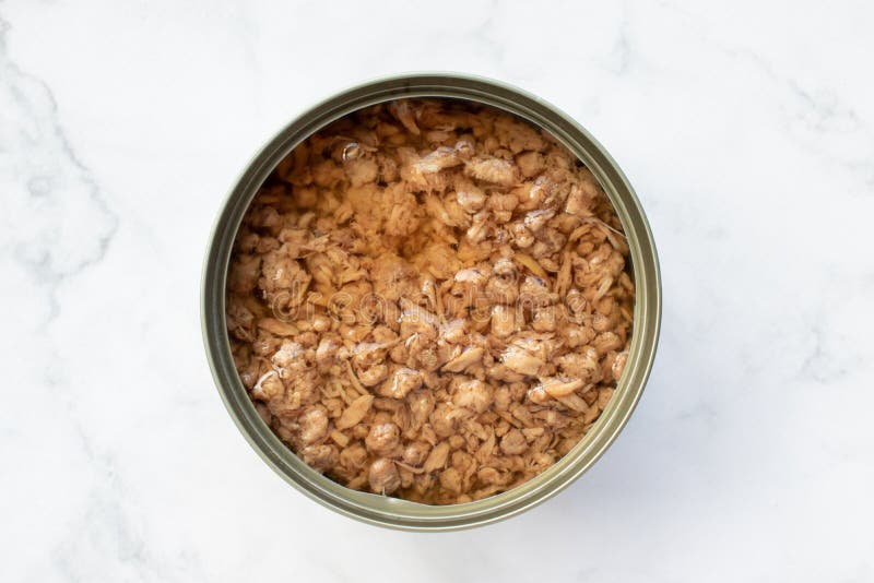 Open Tin Can with Chopped Tuna in Oil on White Marble Kitchen Table ... Open Tin Can with Chopped Tuna in Oil on White Marble Kitchen Table ...