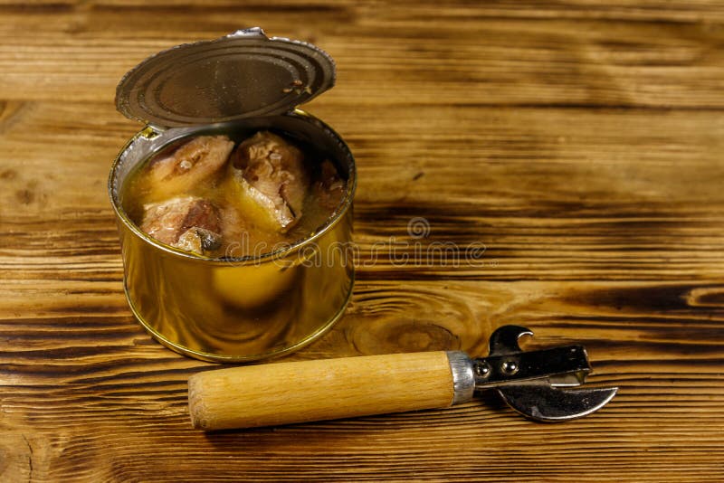 Open Tin Can Of Sardine Fish And Can Opener On Wooden Table Stock Photo ...