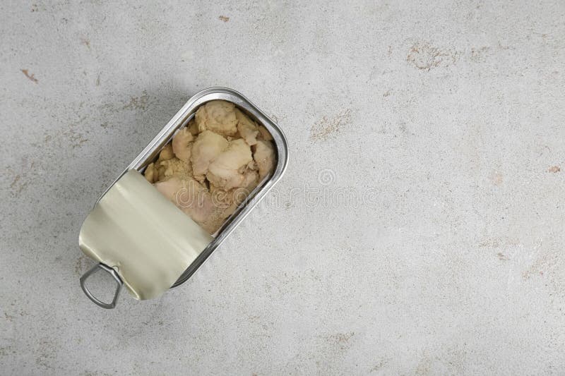 Open Tin Can of Tasty Cod Liver on Textured Table, Top View. Space for ...
