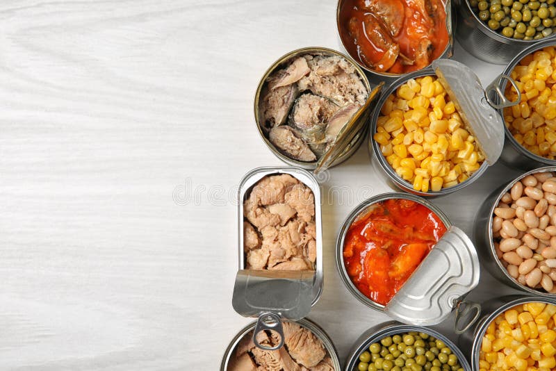 Open Tin Cans with Different Vegetables and Fish Meat on Light Table ...