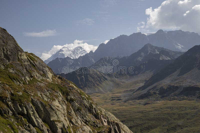 An Open Valley and a Mountain Range with Snow Capped Peaks Stock Photo ...