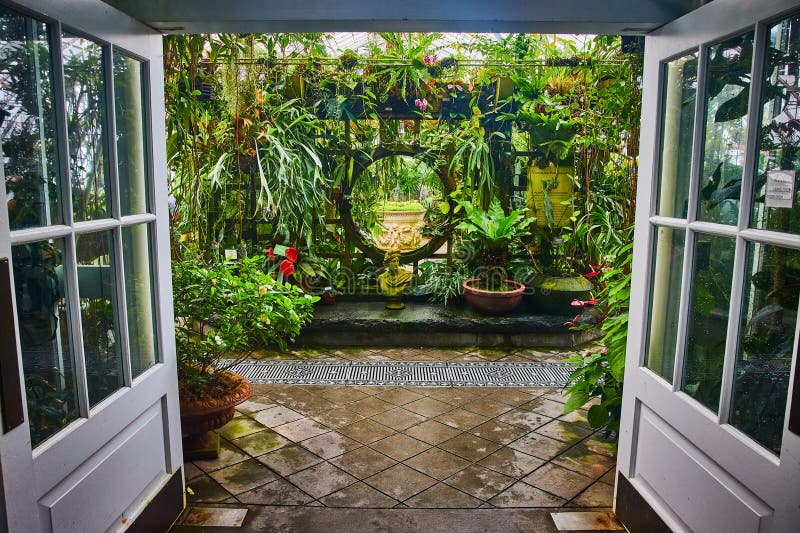 Open White Doors Leading To Moon Gate Inside Trellis Covered in Plants ...