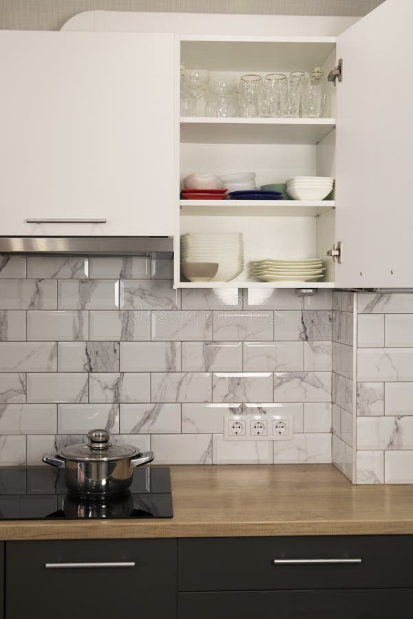 Open White Kitchen Cabinet Door with White Dishes Inside Stock Image ...