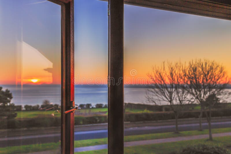 An Open Window, with a Key Lock and Wood Coloured Frame Catches the ...